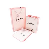 China Carry Custom Paper Shopping Bags 250g Embossed Promotional With Matched PP Rope Handle for sale