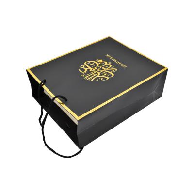 China Durable Black Custom Paper Shopping Bags With Golf Foil Logo for sale