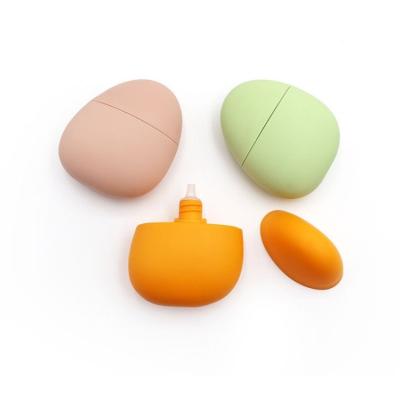 China 40ml Orange Pink Green Pebble Shape Empty Bottle For Sunscreen Lotion Hand Cream for sale