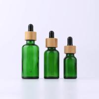 China 100ml 50ml 30  Ml 15ml Green Essential Oil Glass Dropper Bottles Eye Dropper Bamboo Lid Cosmetic Jar for sale