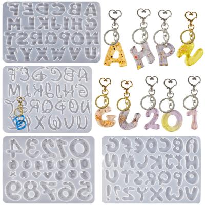 China DIY Drip Glue Resin Mirror 26 English Alphabet Number Irregular Perforated Key Pendant Silicone Mold for sale