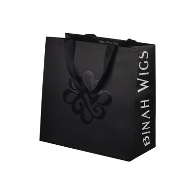 China Customized UV Coating Paper Packaging Bags With Flat Cotton Handle for sale