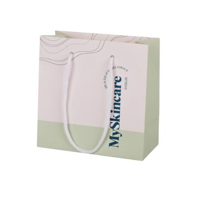 China Shopping Custom Printed Paper Bags Art Paper Matte Lamination With Nylon Rope Handle for sale