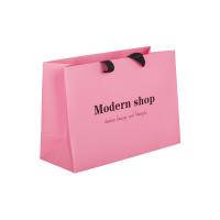 China Pink 250g Coated Paper Bags Packaging Clothing With Ribbon Handle for sale