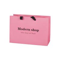 China Pink 250g Coated Paper Bags Packaging Clothing With Ribbon Handle for sale