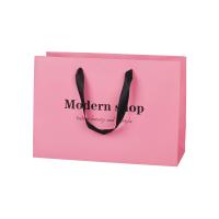 China Pink 250g Coated Paper Bags Packaging Clothing With Ribbon Handle for sale