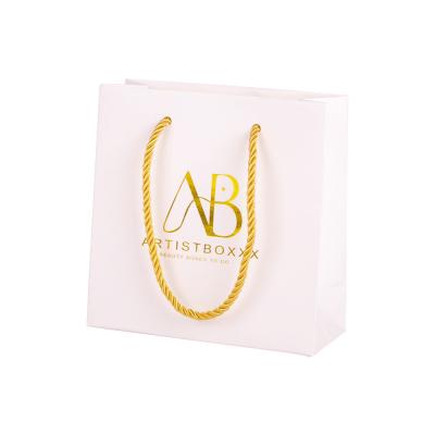 China 100gsm Gold Stamping White Paper Bags Business Shopping Packaging With Handle for sale