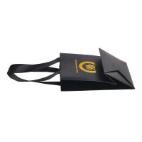 China Gold Stamping Black Paper Bags Shopping Packaging With Ribbon Handle for sale