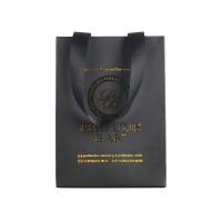 China Gold Stamping Black Paper Bags Shopping Packaging With Ribbon Handle for sale