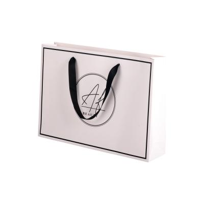 China Ribbon Handle Paper Packaging Bags for Clothing White Art Paper Offset Printing for sale