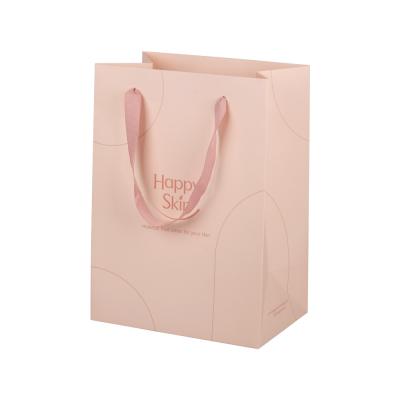 China Eco Friendly Pink Paper Packaging Bags For Cosmetic With Ribbon Handle for sale