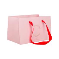 China Biodegradable Pink Stamping Paper Cake Packaging Bags With Ribbon Handle for sale