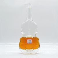 China Big Good 700ml 750g Transparent Glass Packaging for Special Shape Violin Skull Bottle for sale