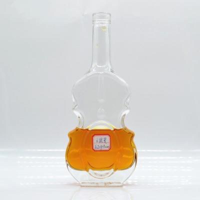 China Big Good 700ml 750g Transparent Glass Packaging for Special Shape Violin Skull Bottle for sale