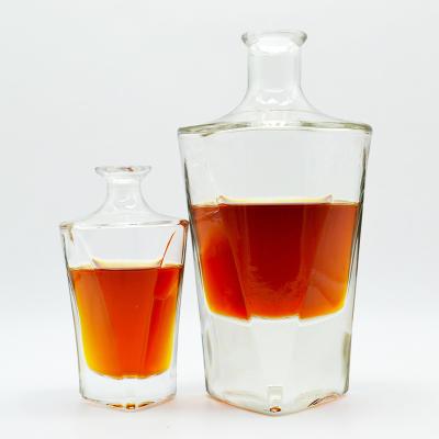 China 750ml Custom Glass Bottle for Spirits Transparent Irregular Shaped Tequila Bottle for sale