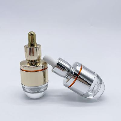 China 30ml 50ml Gold/silver spray essence bottle, essential oil glass bottle, electroplating uv shoulder sleeve dropper bottle for sale