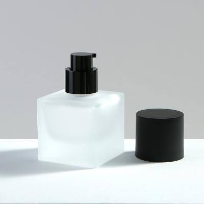 China 30ml liquid foundation frosted glass bottle Square with black pressing lotion pump cosmetic packaging container for sale