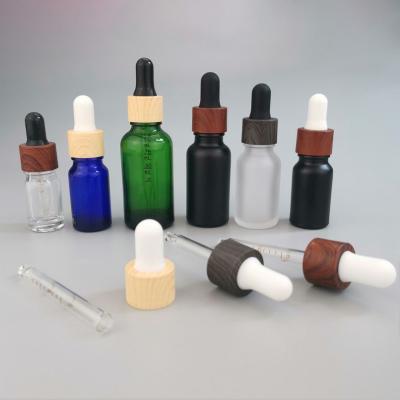 China 5ml 10ml 15ml 30ml 50ml transparent empty glass dropper essential oil bottle with bamboo wood grain water transfer lid for sale