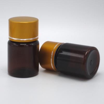 China Amber Glass Pill Bottle 25ml 50ml With Aluminum Gold Cap for sale