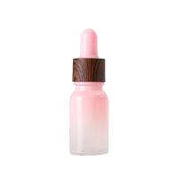 China 5ml 10ml 20ml 30ml Pink Essential Oil Glass Bottle Dropper With Wood Frosted Pipettes for sale