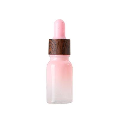 China 5ml 10ml 20ml 30ml Pink Essential Oil Glass Bottle Dropper With Wood Frosted Pipettes for sale