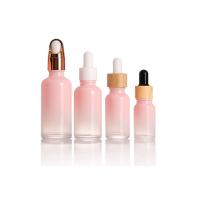 China Pink Glass Dropper Bottle With Natural Bamboo Wooden Dropper for sale