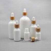 China 10ml-100ml Essential Oil Bottle 50ml Bamboo Lid White Porcelain/Amber Platinum Essential Oil Bottle Anti-theft Cap for sale