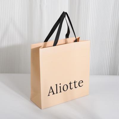 China Custom Black Kraft Paper Bag with Logo Recyclable Handle for Clothing Packaging 30x40cm for sale