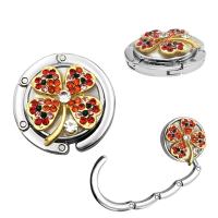 China Custom Logo Metal Folded Round Purse Hooks Colored Diamond Clover Bag Hanger for sale